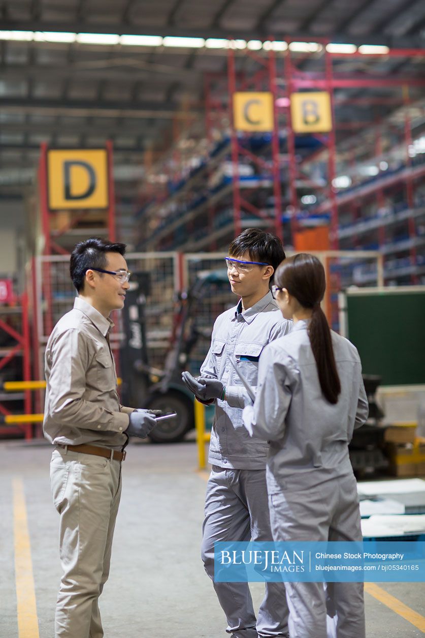 Confident Chinese engineers talking in the factory-High-res stock photo ...