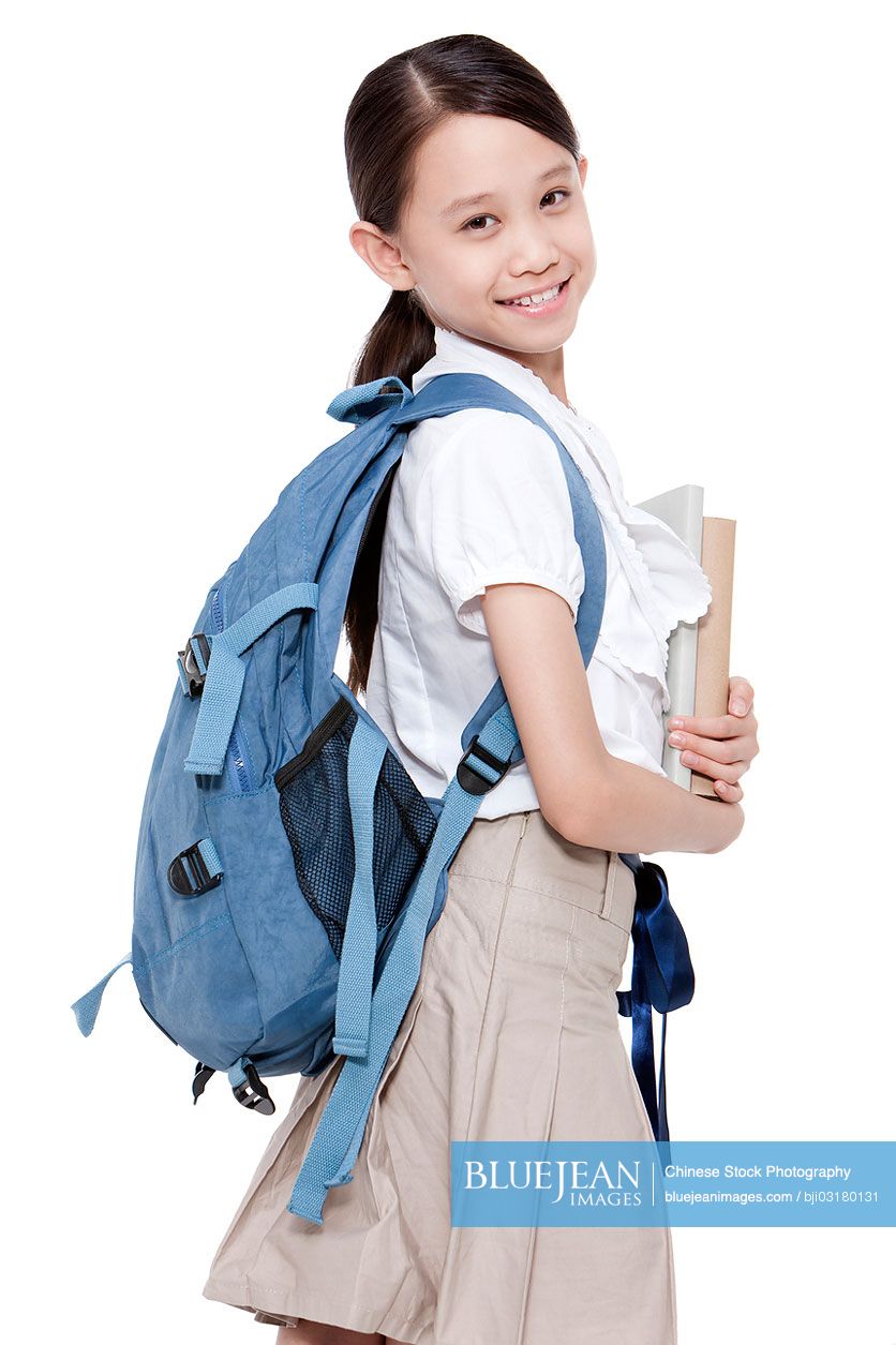 Happy Chinese schoolgirl with books and schoolbag on the back-High-res ...