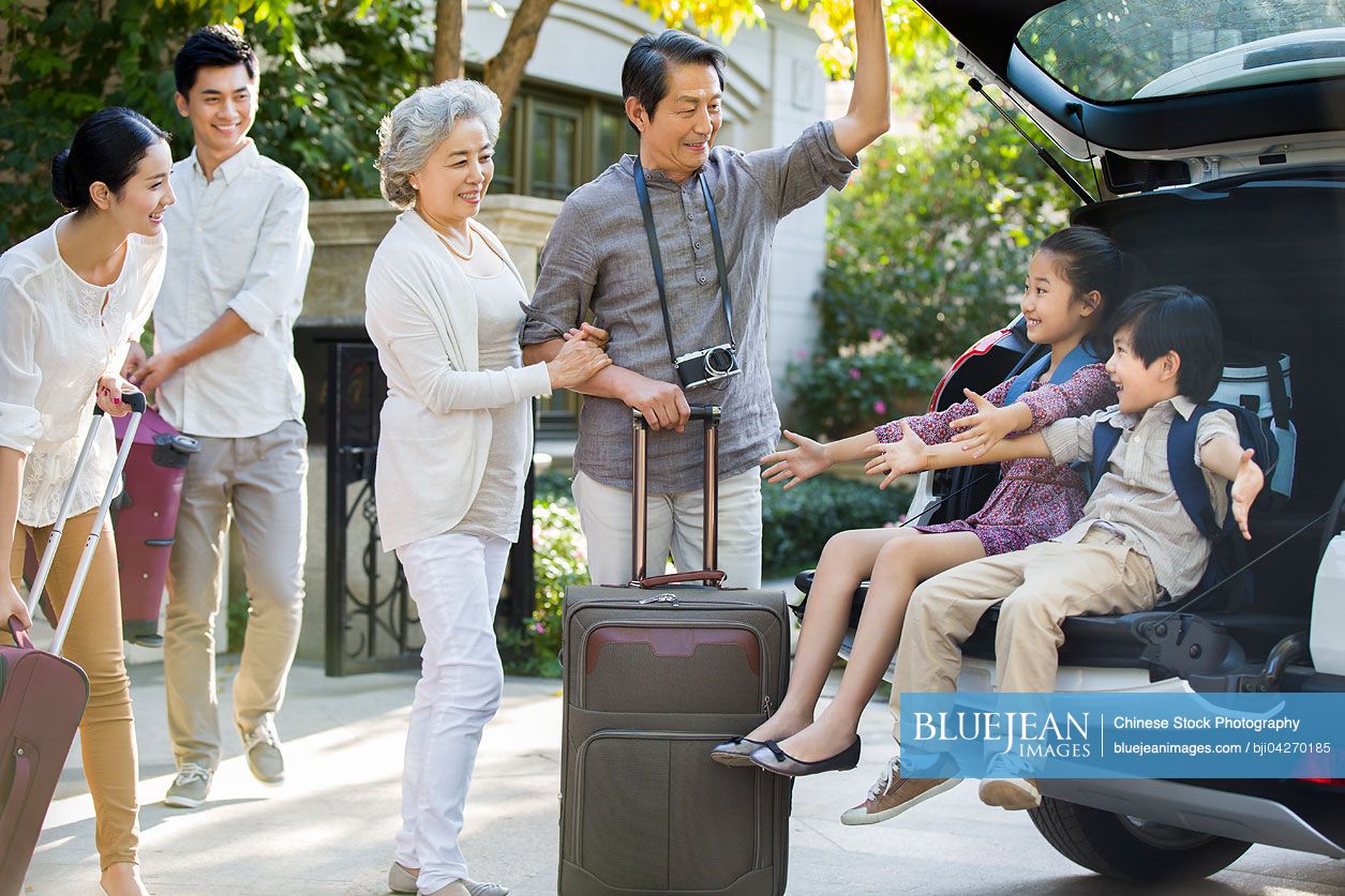Happy Chinese family packing for car trip-High-res stock photo for download