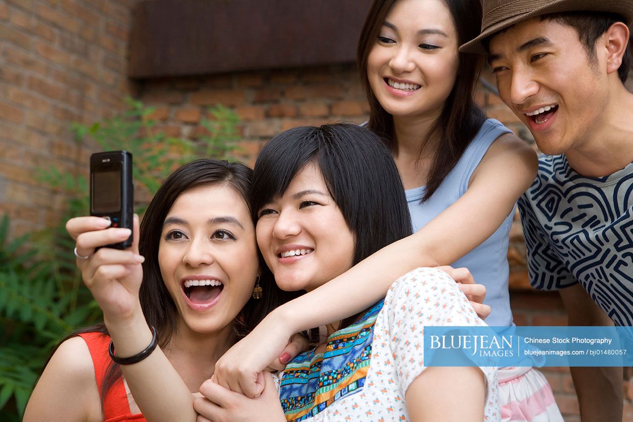 Chinese friends taking photos with mobile phone-High-res stock photo ...