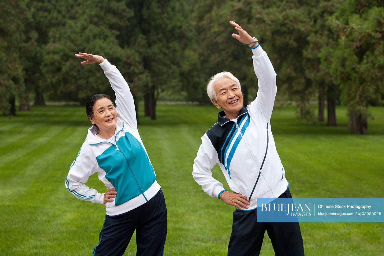 Senior Chinese couple stretching in a park-High-res stock photo for download