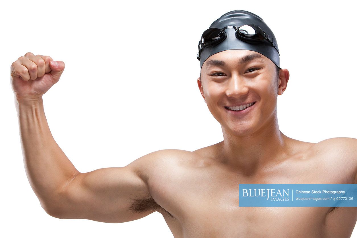 Chinese swimmer flexing his muscles-High-res stock photo for download