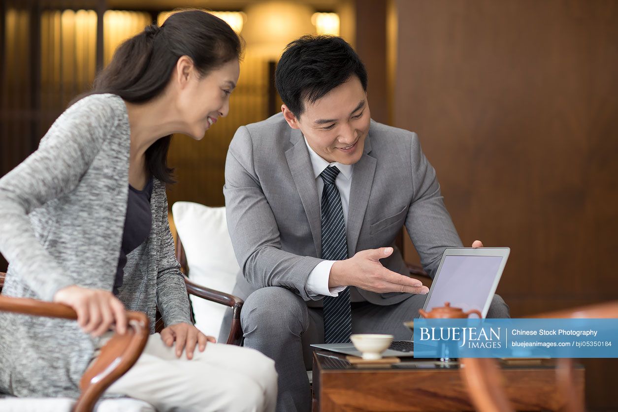 Confident Chinese businessman talking with a mature woman-High-res ...