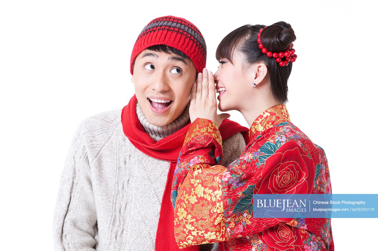Excited young Chinese couple whispering-High-res stock photo for download