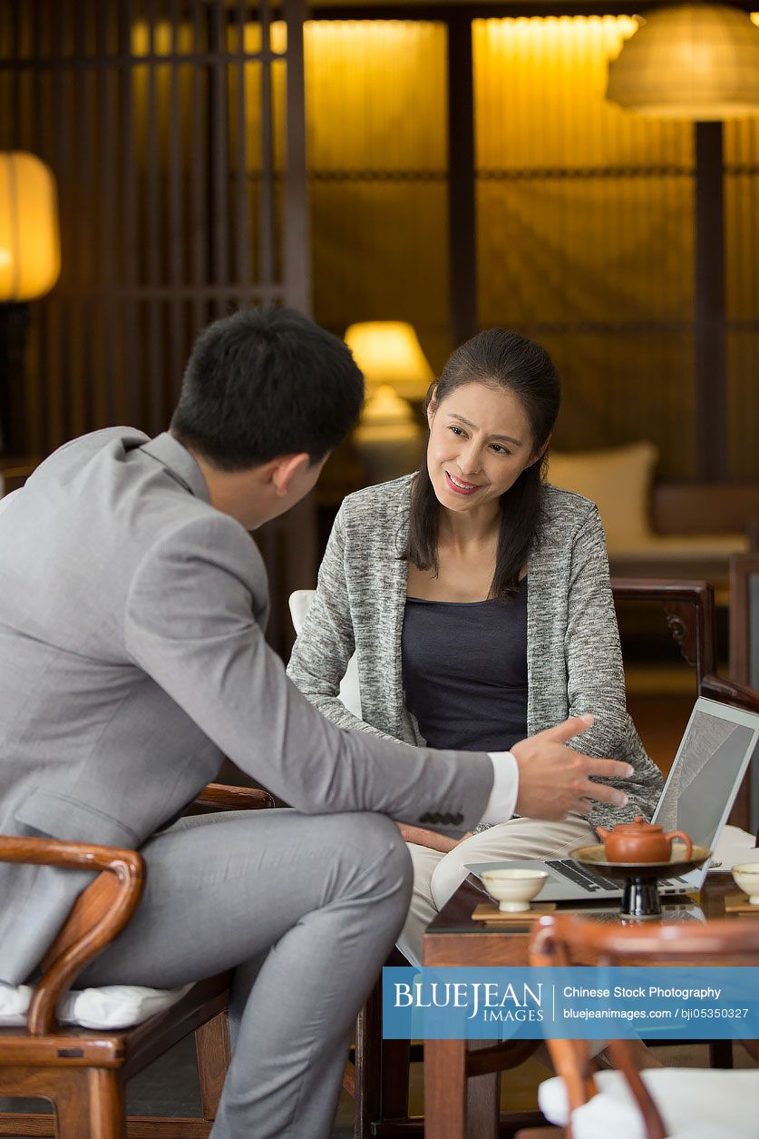 Confident Chinese financial consultant talking with a mature woman-High ...