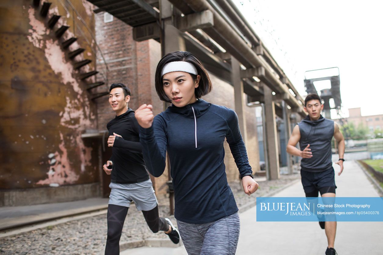 Young Chinese friends jogging outdoors-High-res stock photo for download