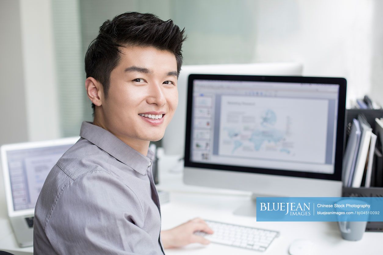 Young Chinese businessman using computer in office-High-res stock photo for download