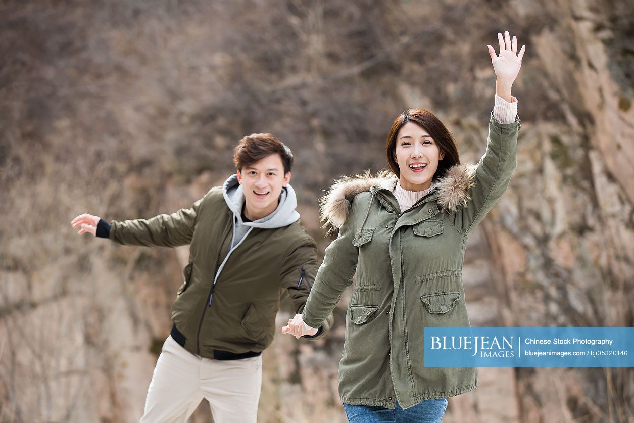 Happy young Chinese couple enjoying winter outing-High-res stock photo for download