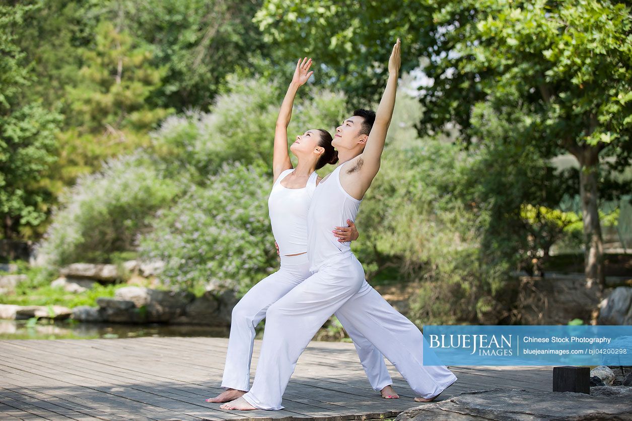 Young Chinese couple doing yoga-High-res stock photo for download