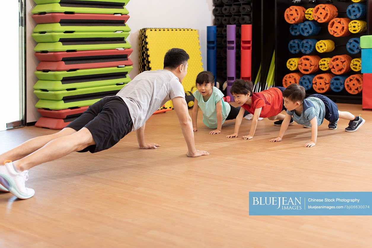 Cute Chinese children having exercise class in gym-High-res stock photo ...