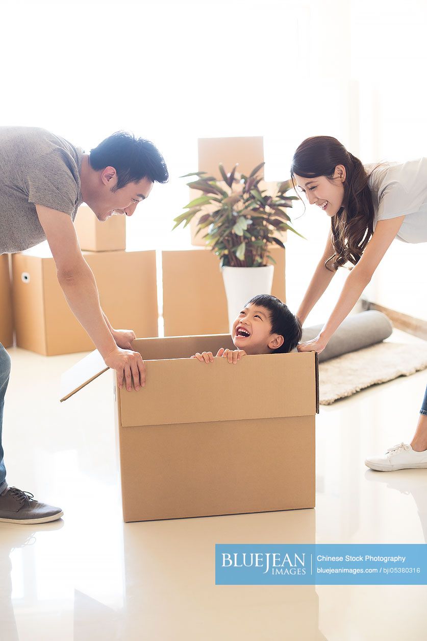 Happy young Chinese family moving to a new house-High-res stock photo ...