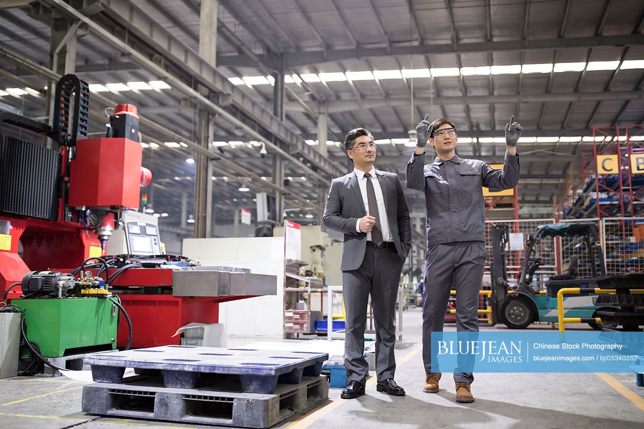 Chinese businessman and engineer talking in the factory-High-res stock ...