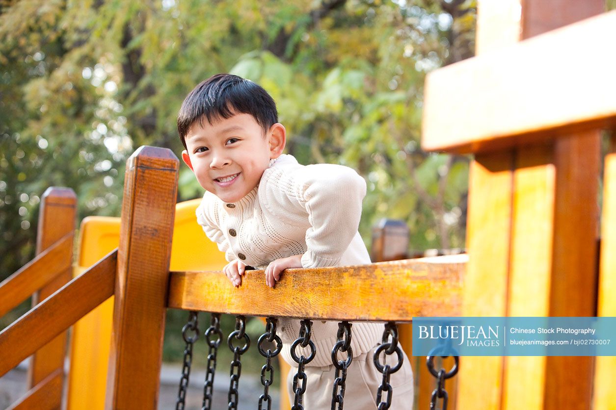 Chinese boy playing on playground toy bridge-High-res stock photo for ...