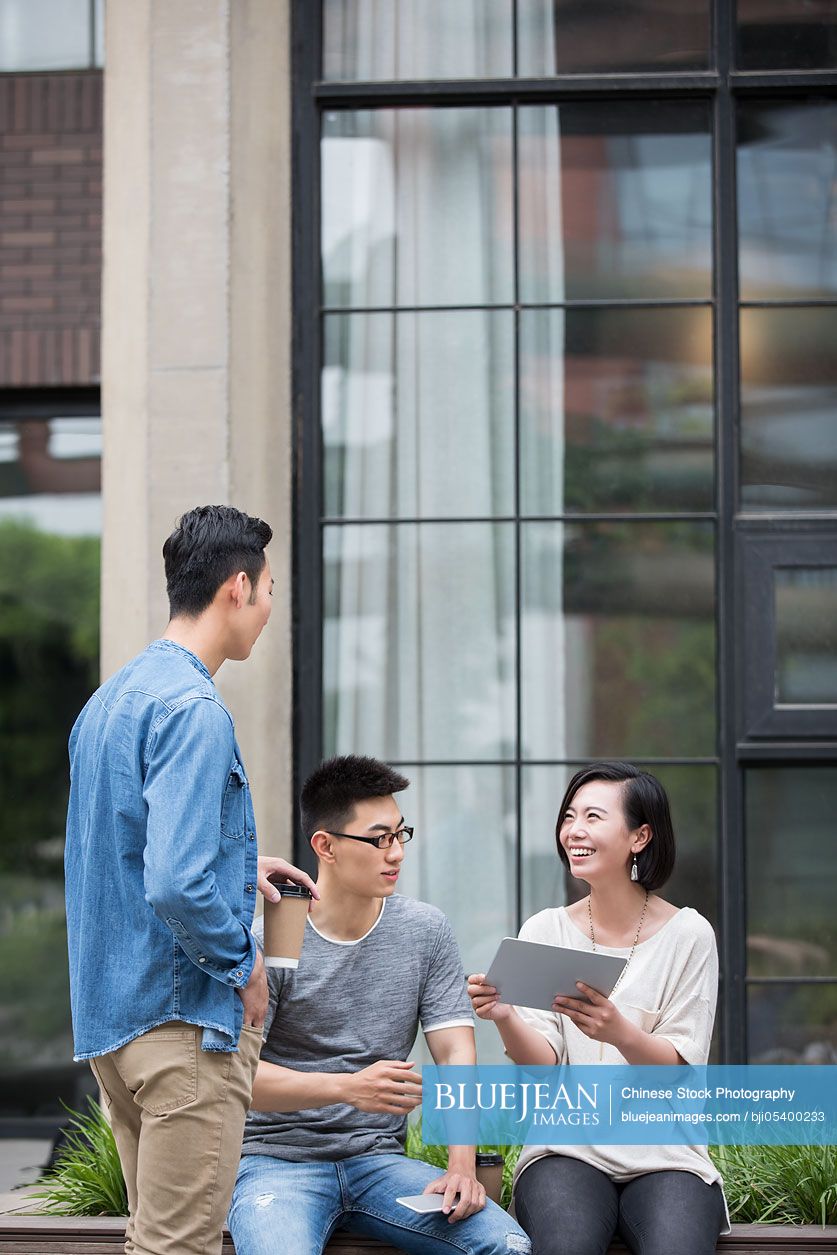 Confident Chinese designer team talking outdoors-High-res stock photo ...