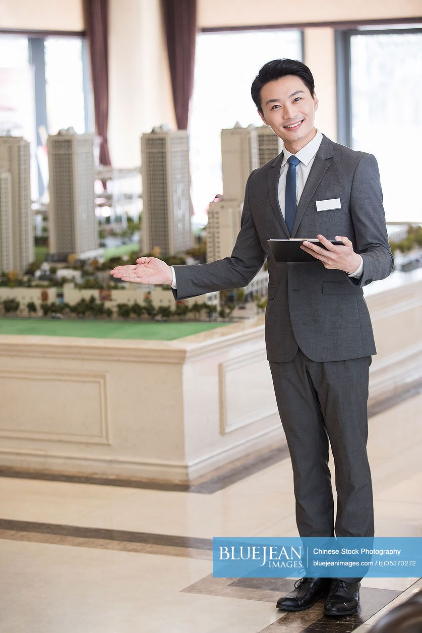 Confident Chinese male realtor greeting-High-res stock photo for download