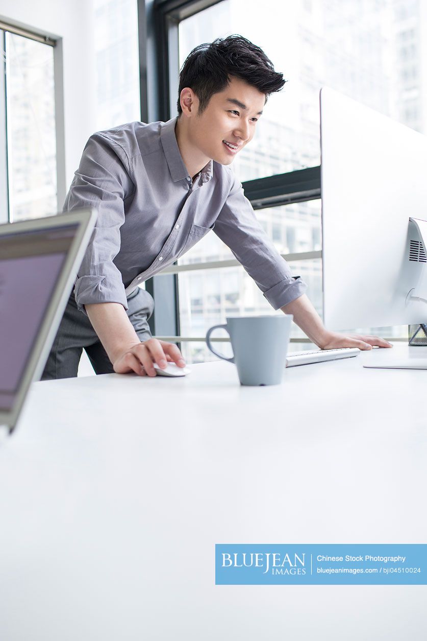 Young Chinese businessman using computer in office-High-res stock photo for download