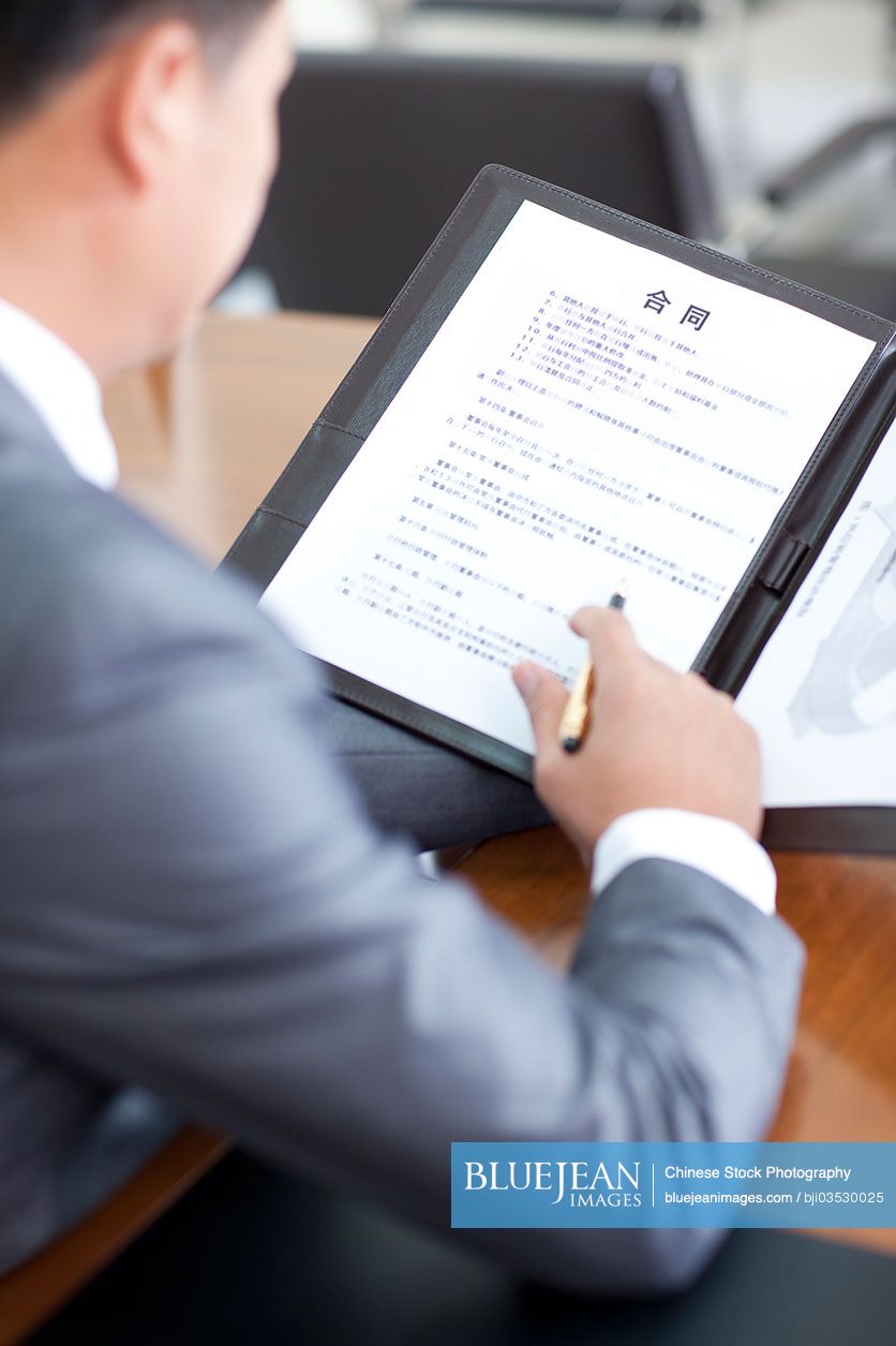 Chinese businessman signing contract in office-High-res stock photo for ...