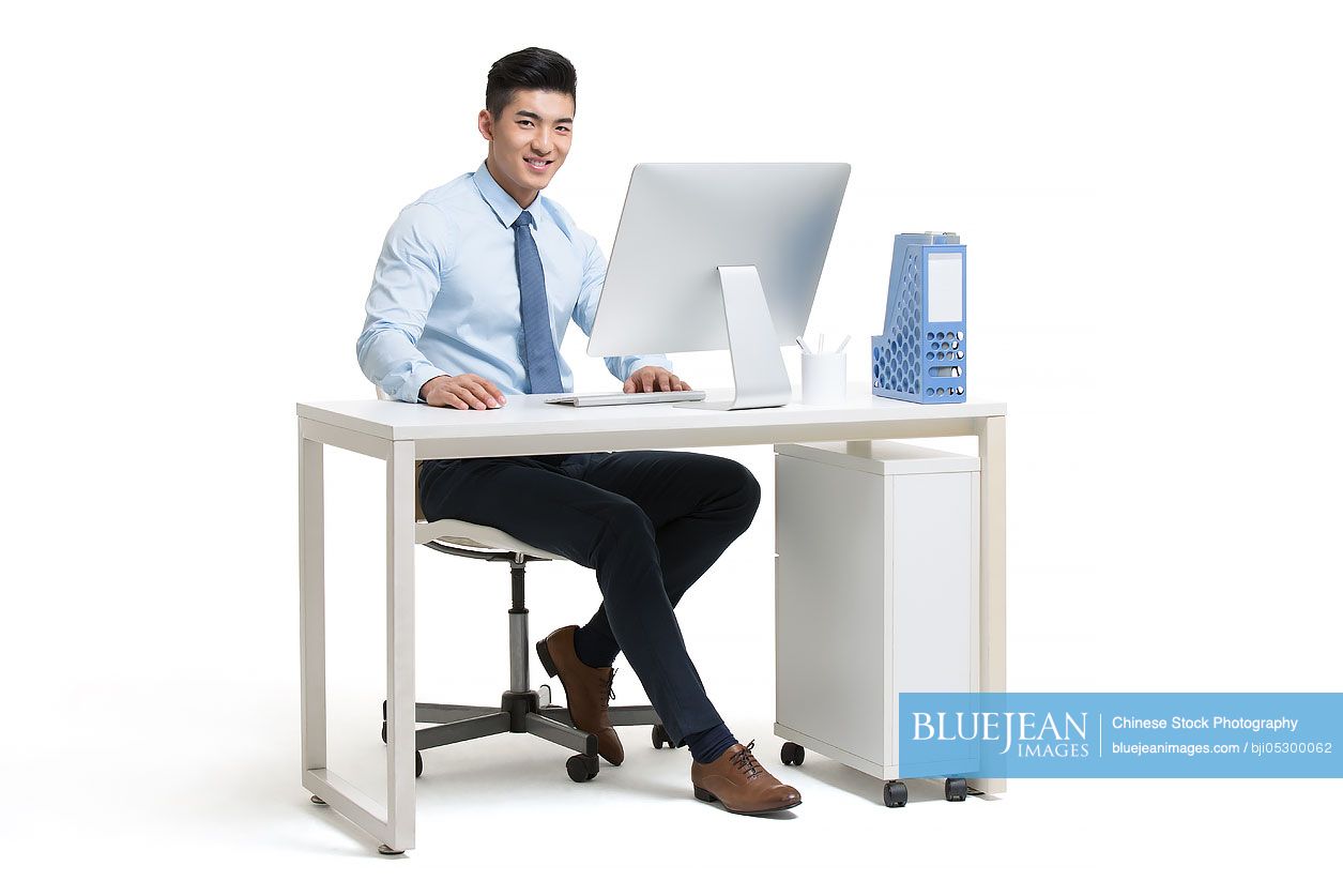 Cheerful young Chinese businessman working in office-High-res stock ...