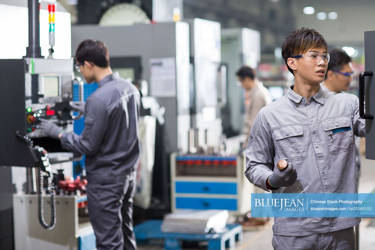 Confident Chinese engineers working in the factory-High-res stock photo ...