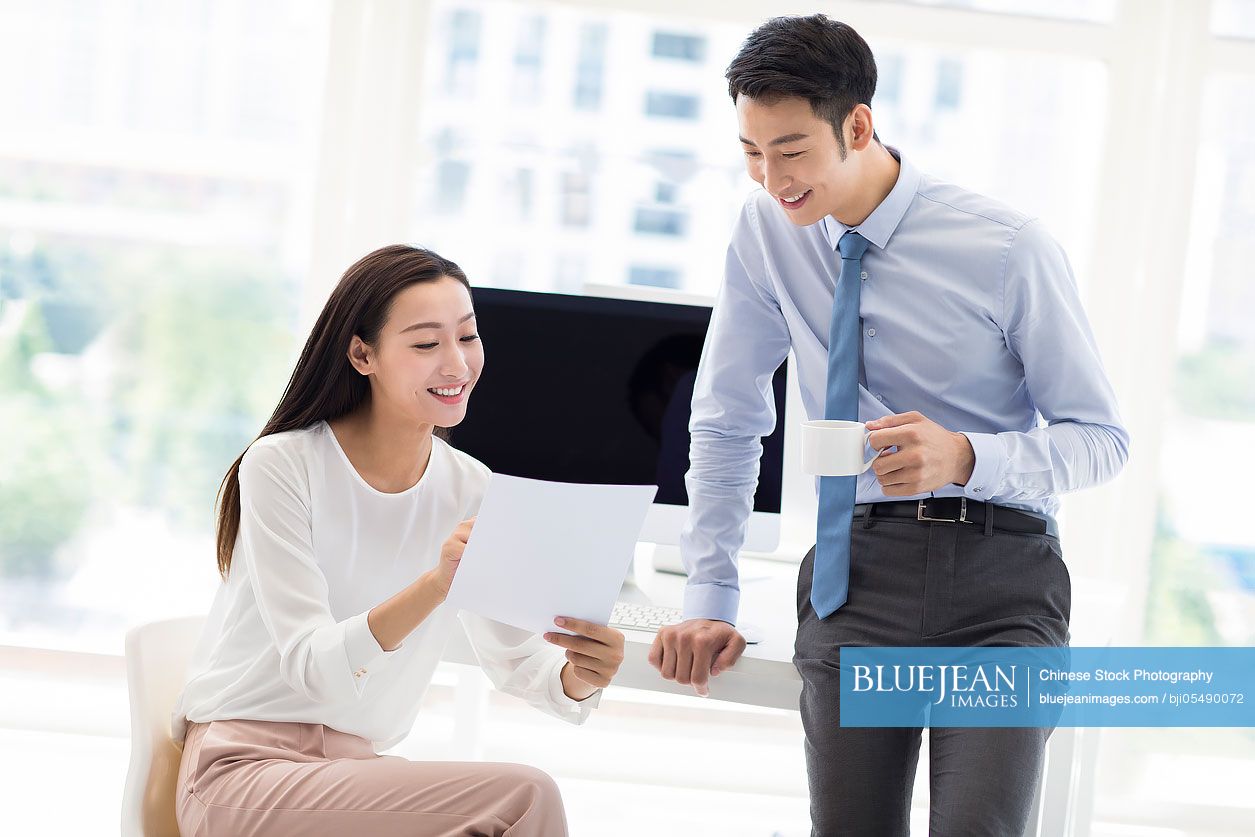Confident Chinese business people talking in office-High-res stock photo for download