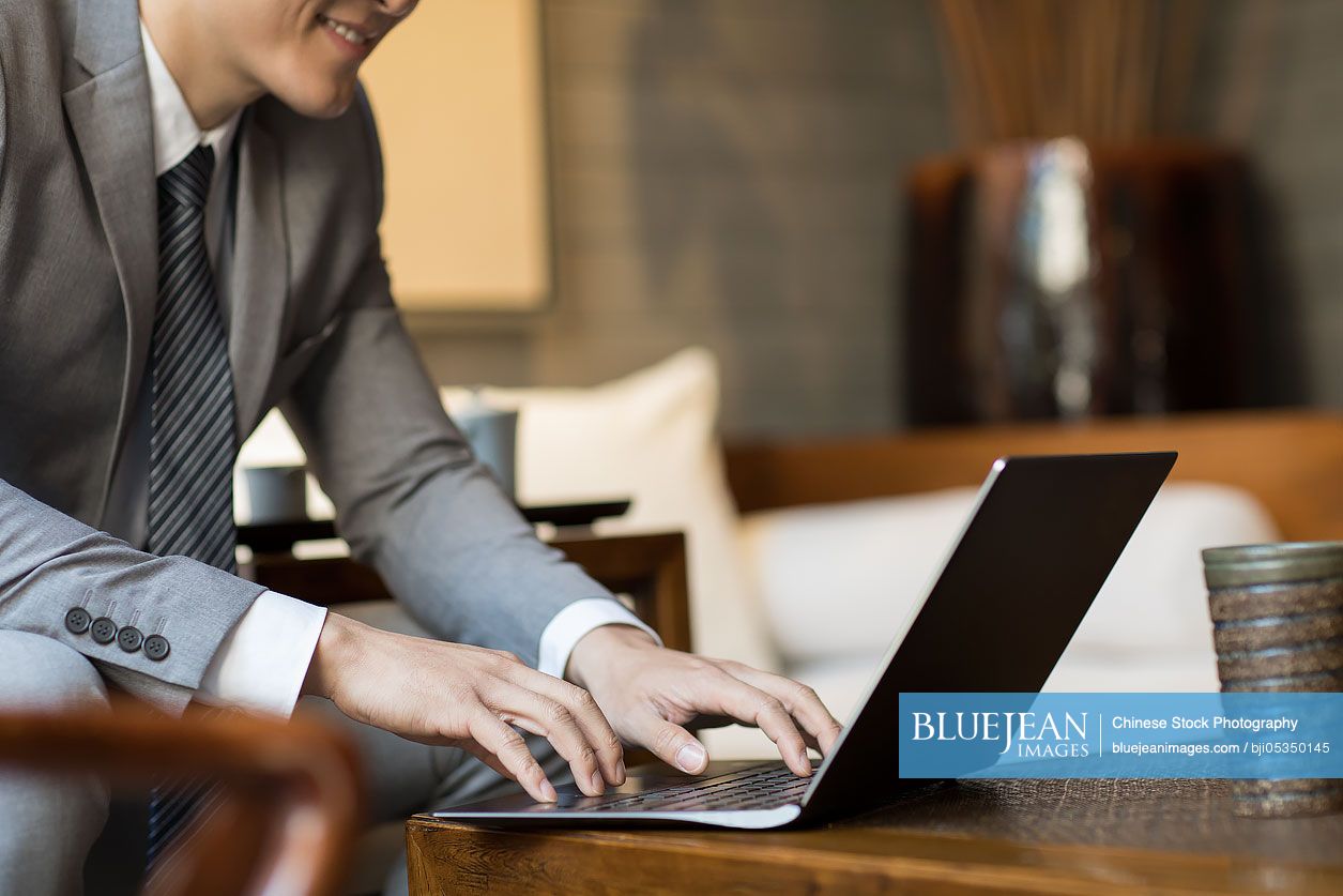 Confident Chinese businessman using laptop-High-res stock photo for ...