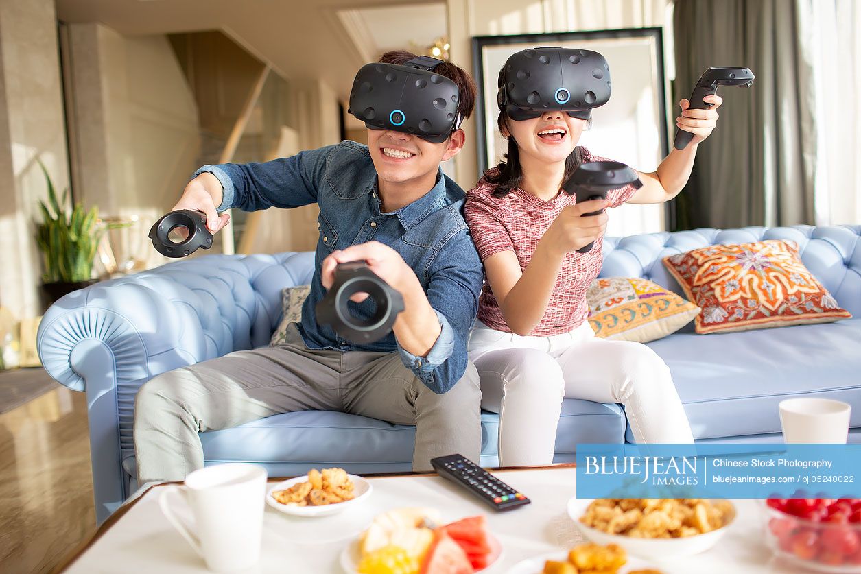 Young Chinese couple playing VR game-High-res stock photo for download