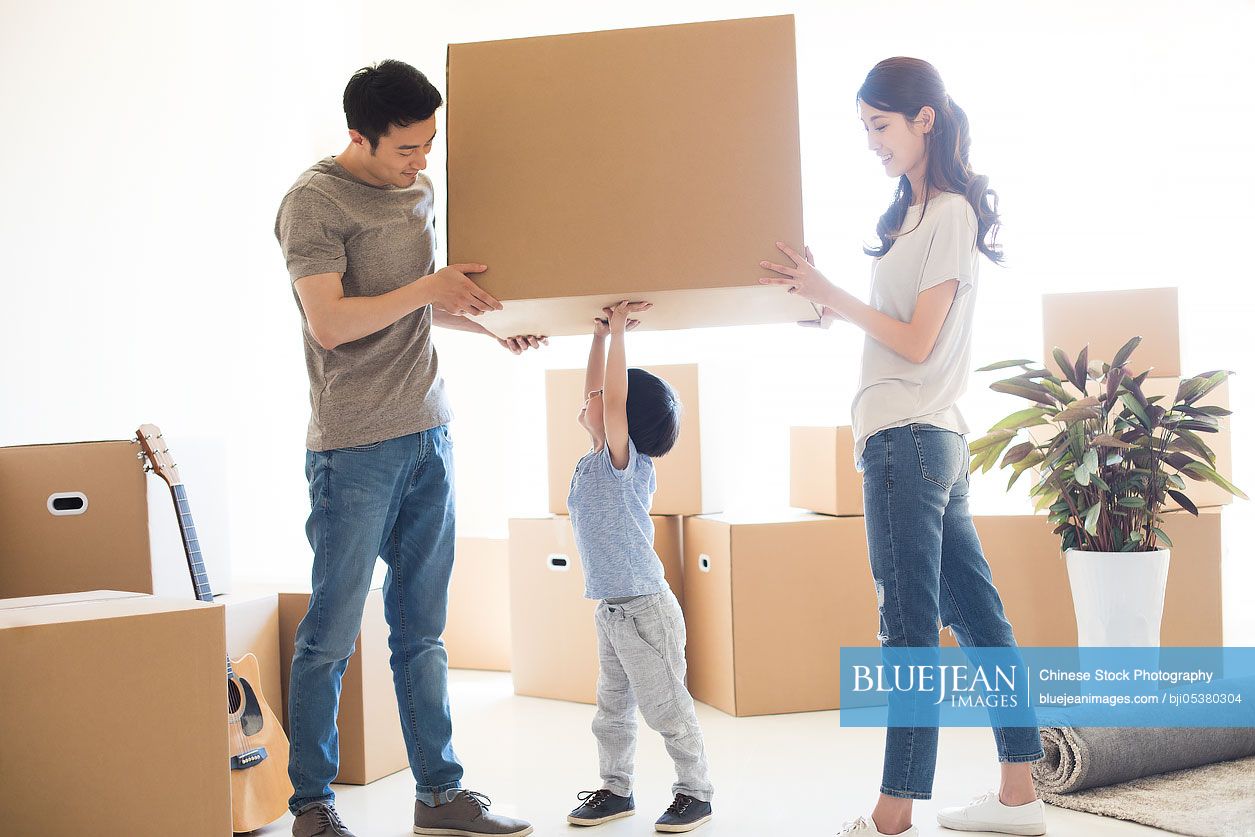 Happy young Chinese family moving to a new house-High-res stock photo ...