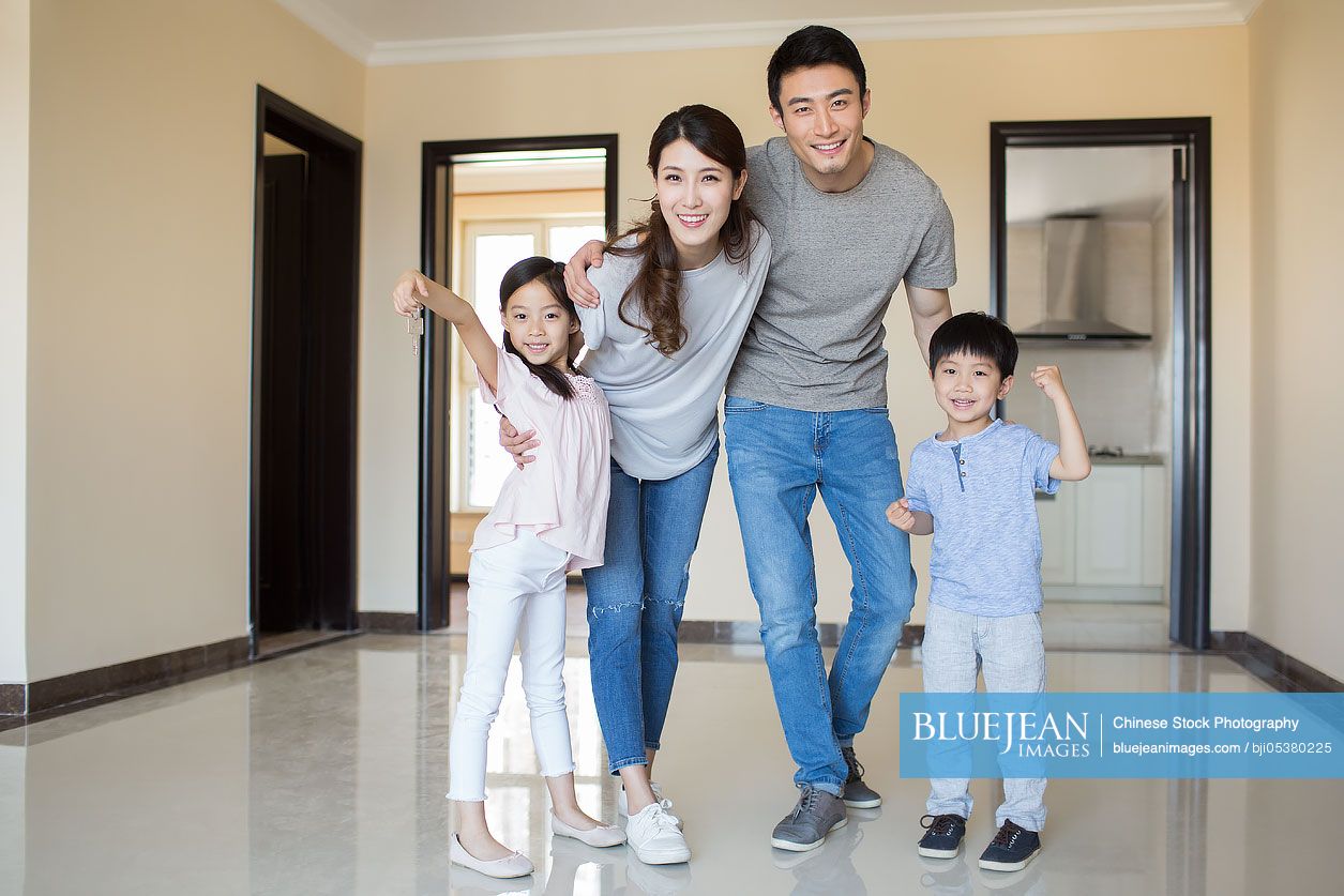 Happy young Chinese family holding keys in their new house-High-res ...