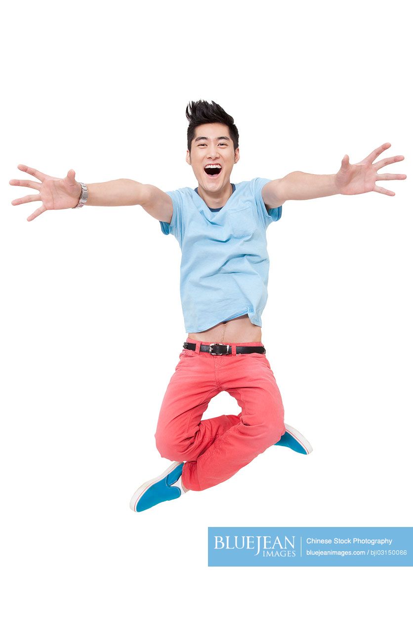 Happy young Chinese man jumping-High-res stock photo for download