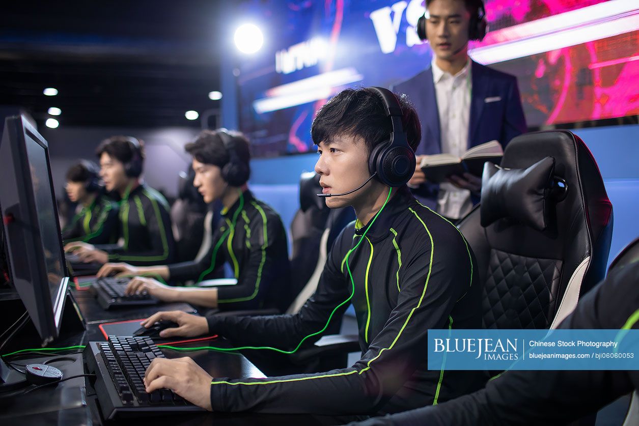 Young Chinese man coaching gamer playing esports-High-res stock photo ...