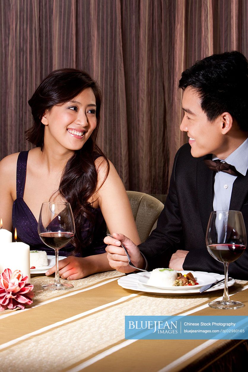 Young Chinese couple having romantic dinner-High-res stock photo for download