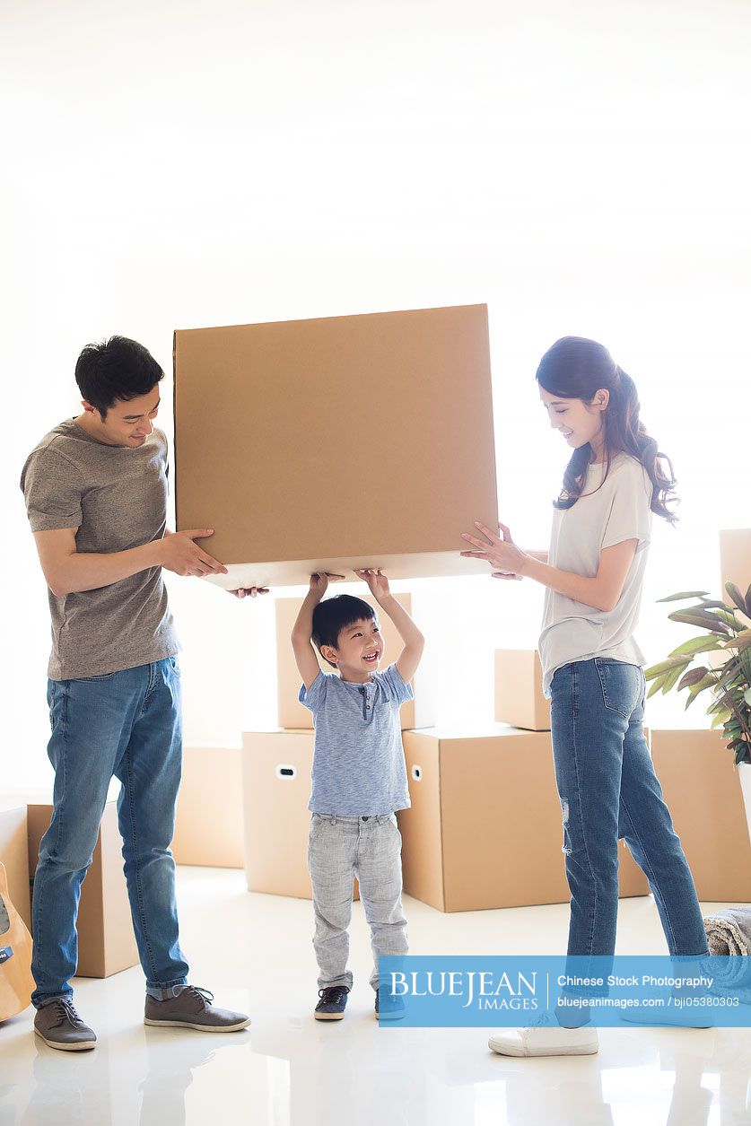 Happy young Chinese family moving to a new house-High-res stock photo ...
