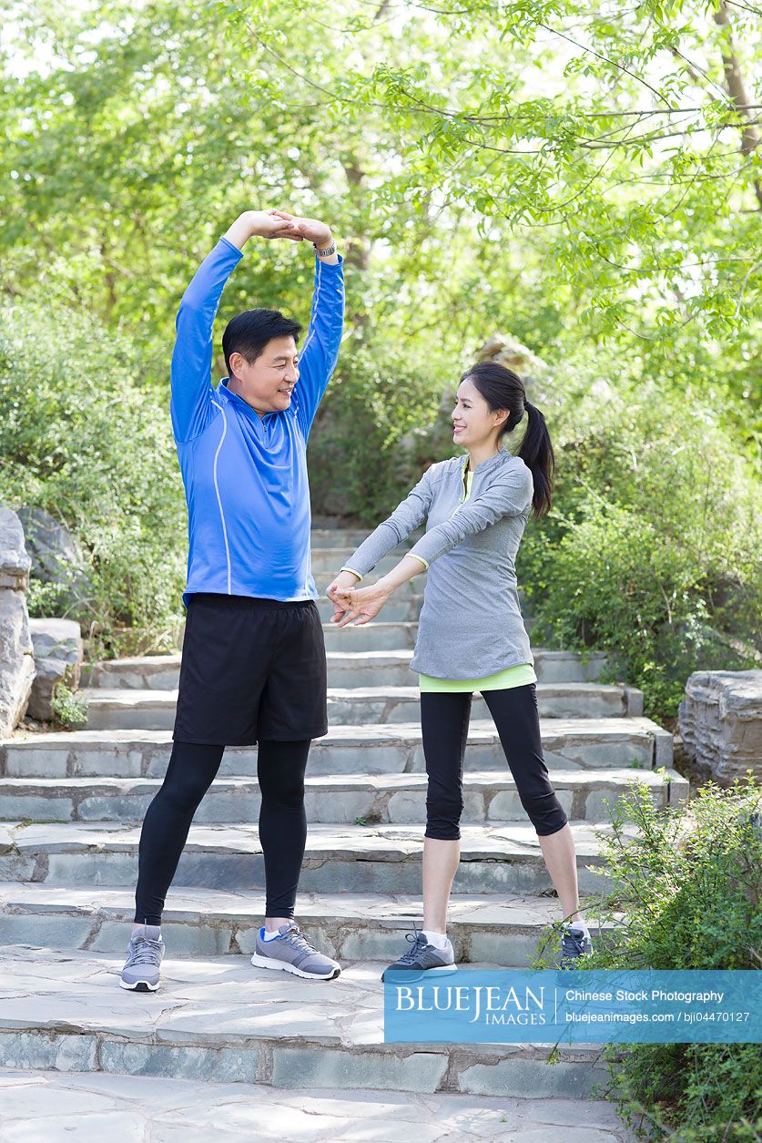 Happy mature Chinese couple exercising in park-High-res stock photo for download