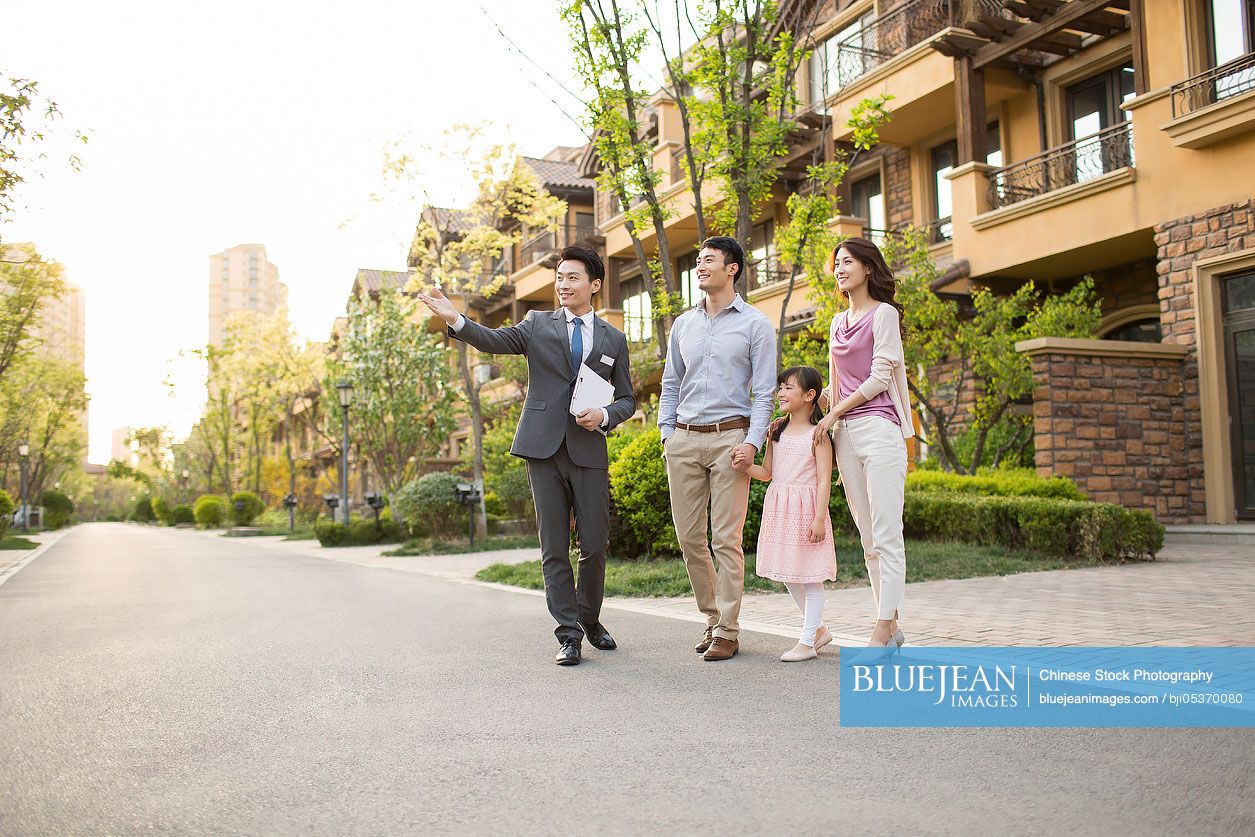 Happy young Chinese family talking with realtor-High-res stock photo for download