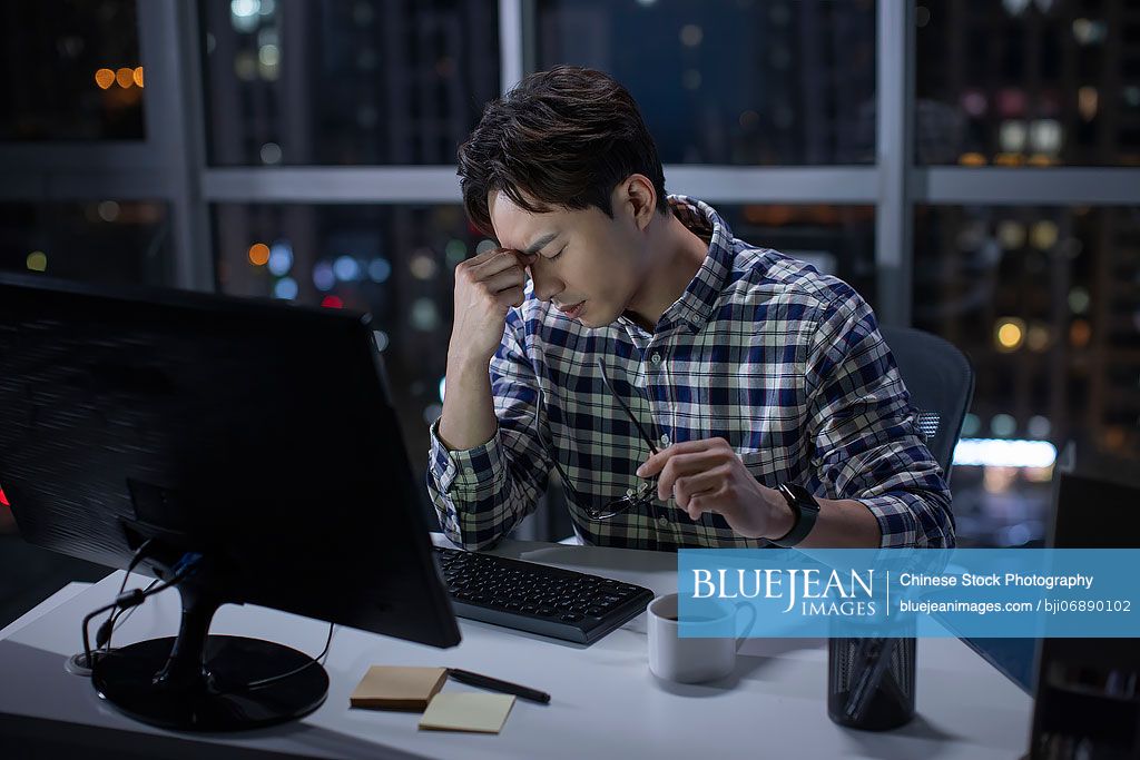 Chinese IT worker working in office at night-High-res stock photo for ...