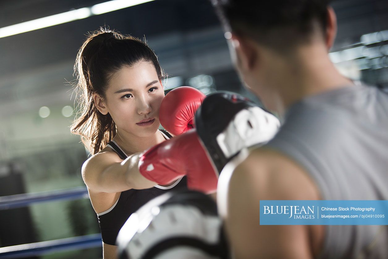 Female Chinese boxer training with coach-High-res stock photo for download