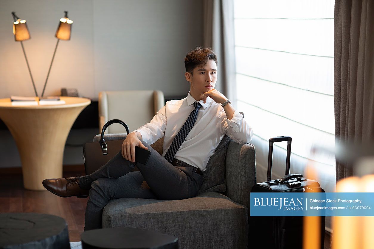 Young Chinese businessman in hotel room-High-res stock photo for download