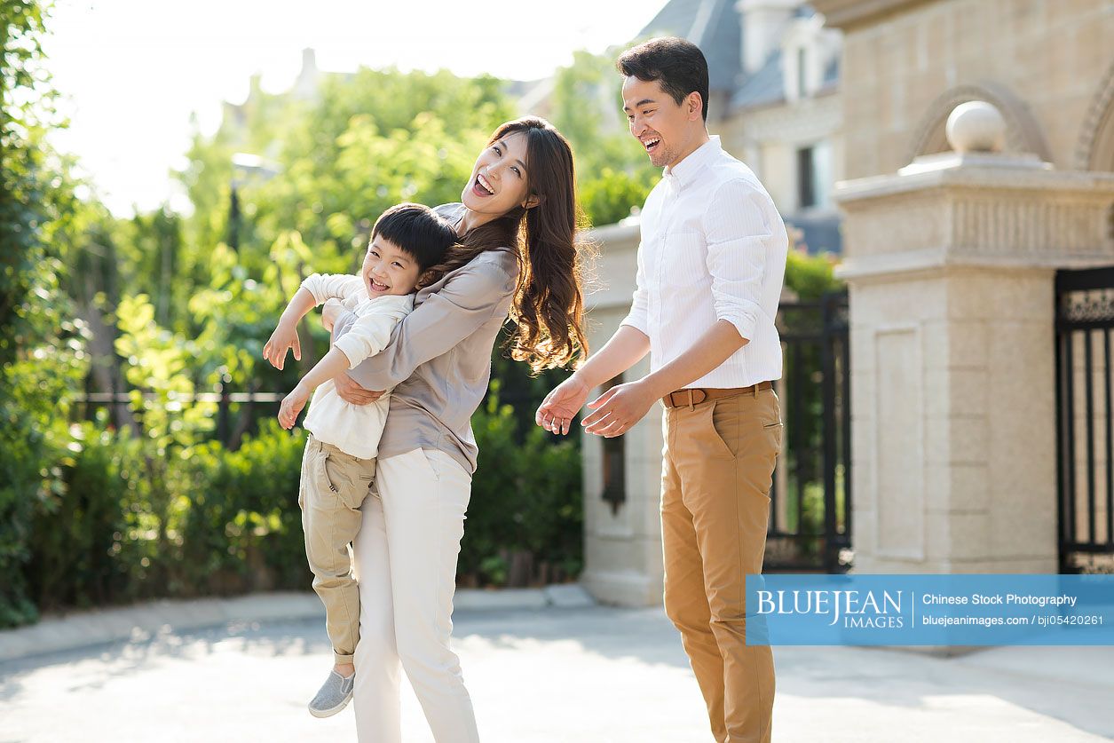 Happy young Chinese family playing outside-High-res stock photo for ...