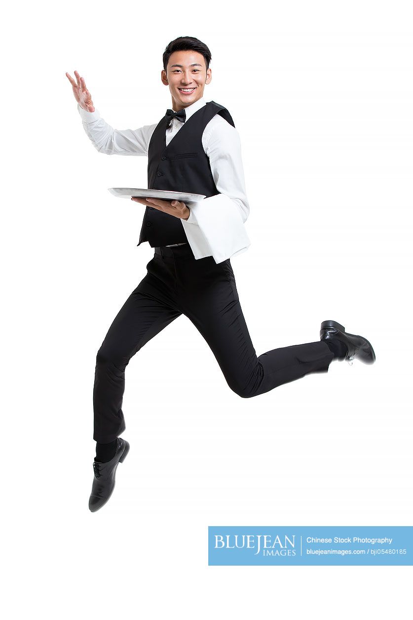 Cheerful young Chinese waiter serving food-High-res stock photo for ...