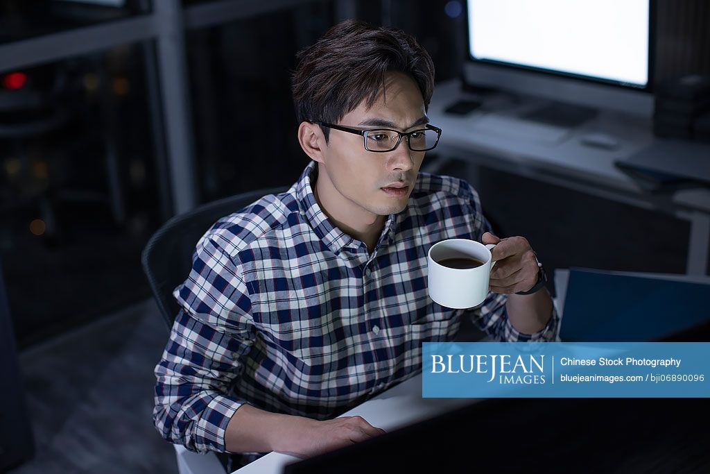 Chinese IT worker working in office at night-High-res stock photo for ...