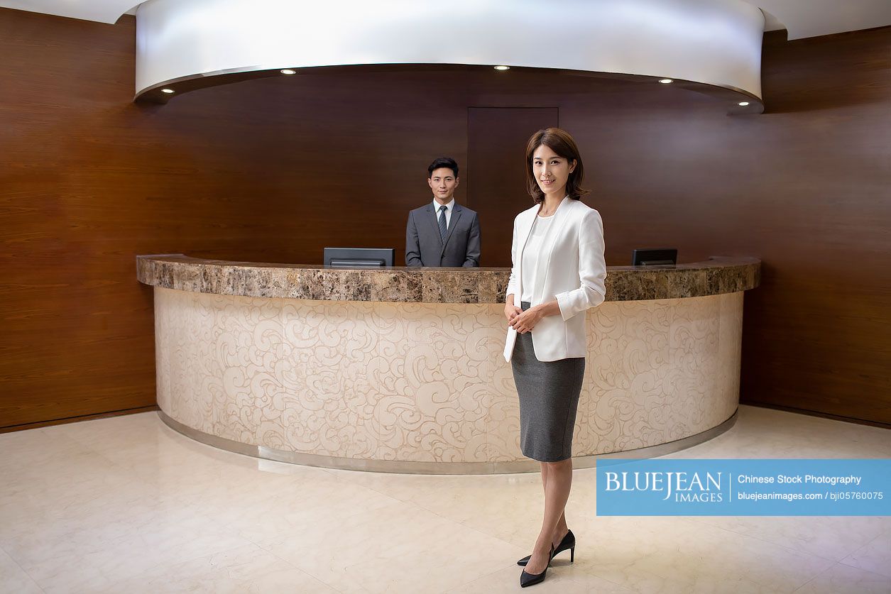 Chinese hotel receptionists at front desk-High-res stock photo for download
