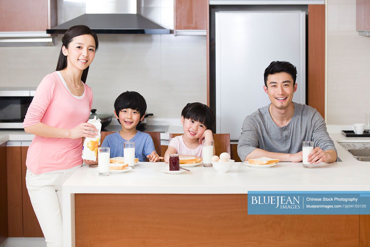 Happy Chinese family having breakfast-High-res stock photo for download