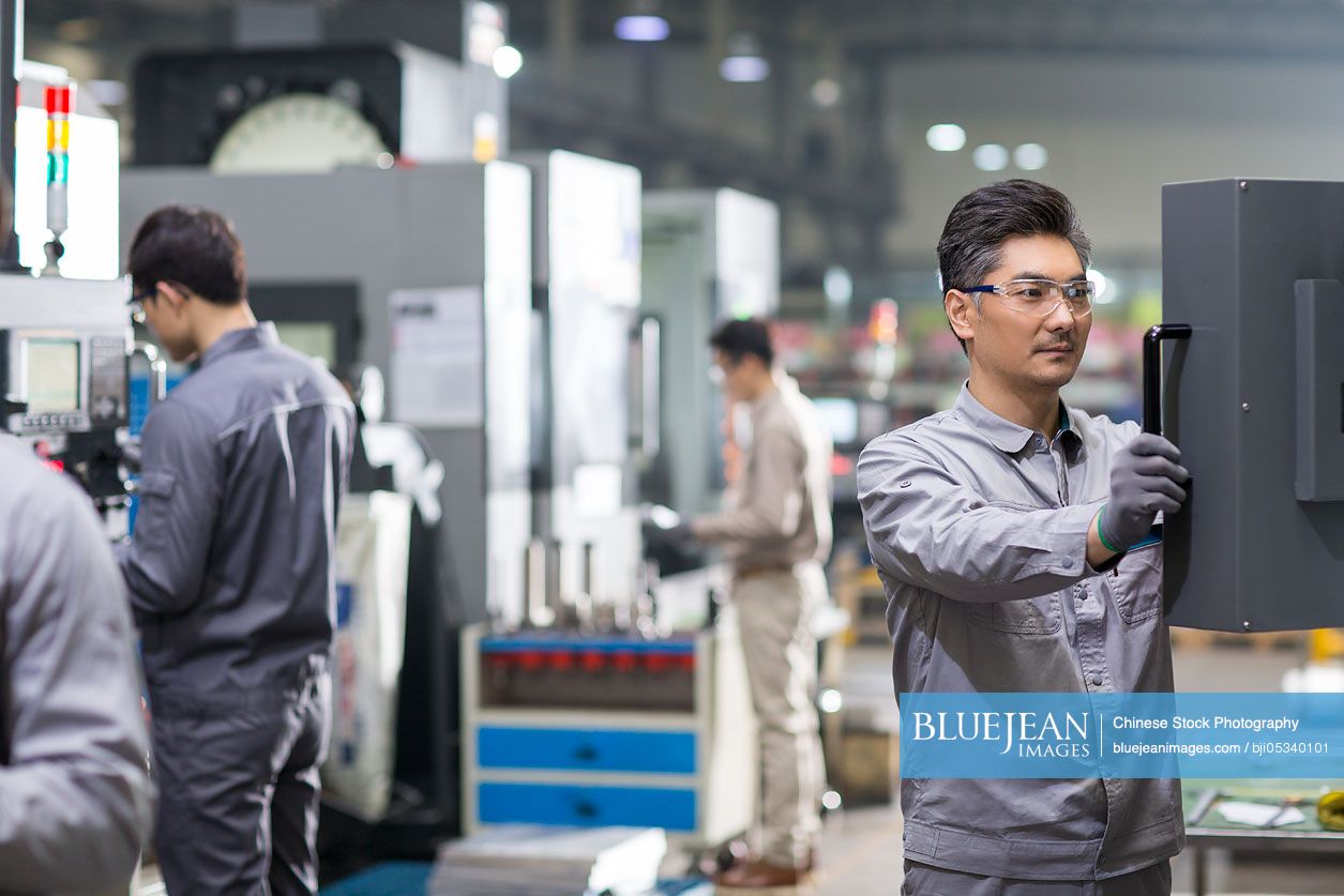 Confident Chinese engineers working in the factory-High-res stock photo ...