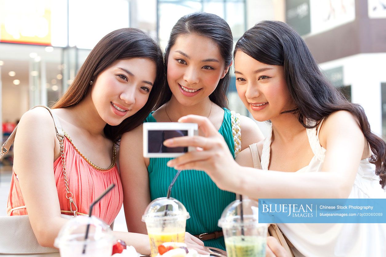 Best female Chinese friends sitting at sidewalk café-High-res stock ...