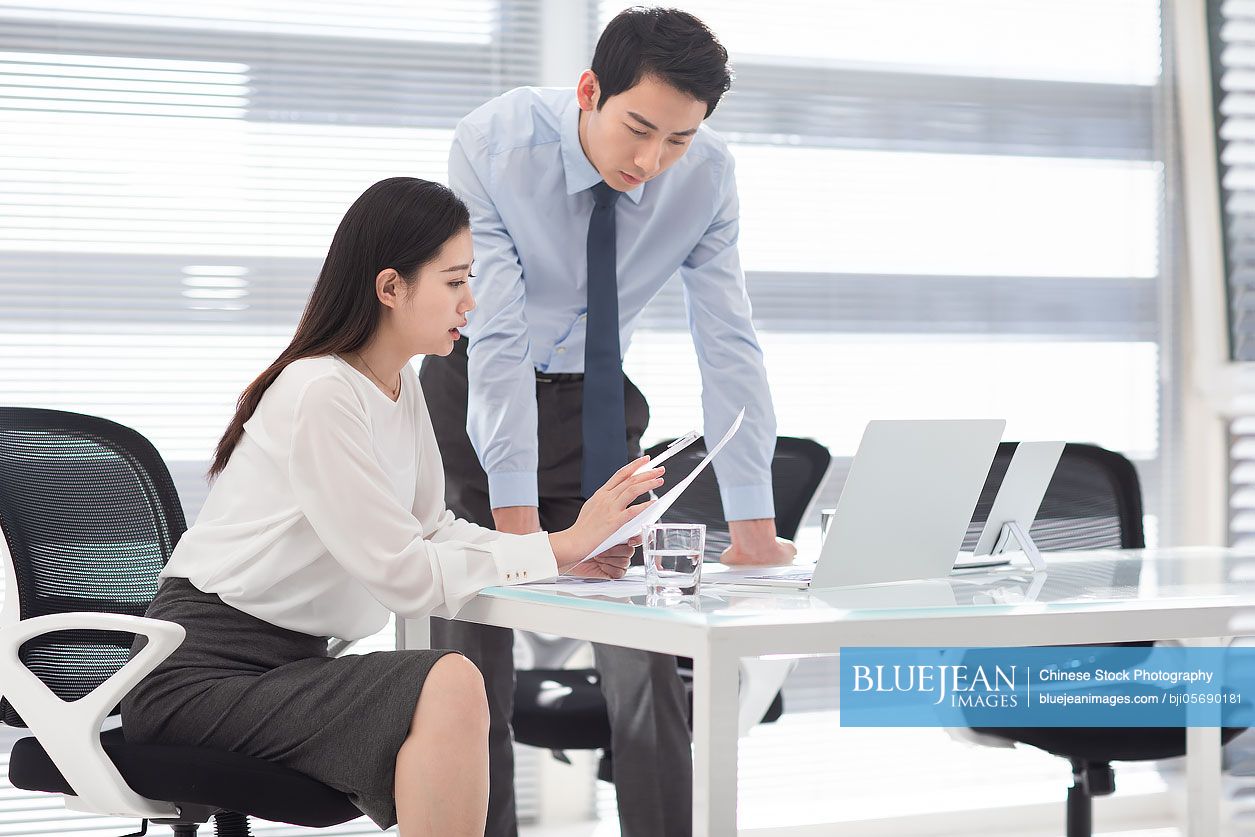 Young Chinese business people using laptop in office-High-res stock photo for download