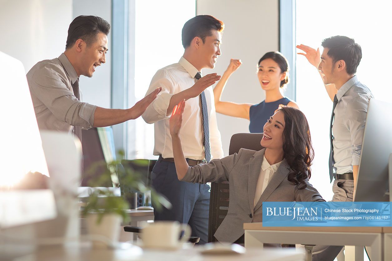 Successful Chinese business people celebrating in office-High-res stock ...