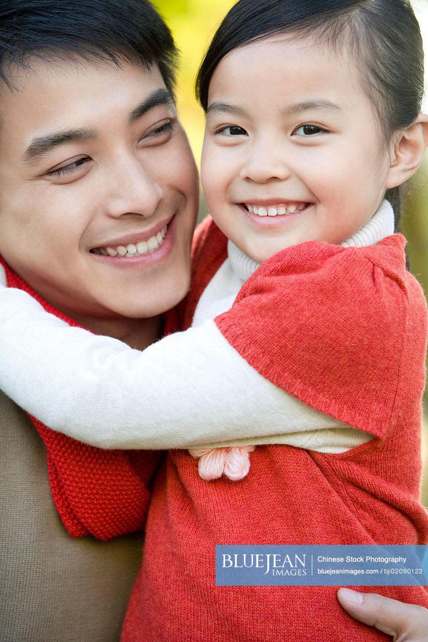 Chinese Father And Daughter Enjoying A Park In Autumn High res Stock