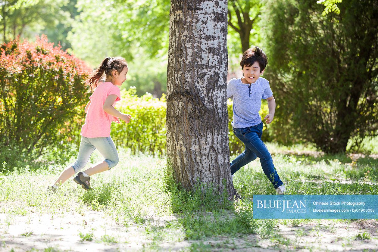 Happy Chinese children playing in woods-High-res stock photo for download