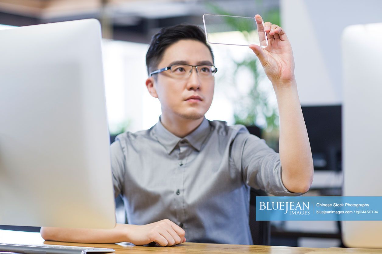 Chinese IT worker developing smart phone-High-res stock photo for download