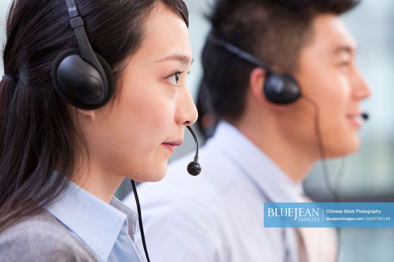 Side view of Chinese call center agents with headsets-High-res stock ...